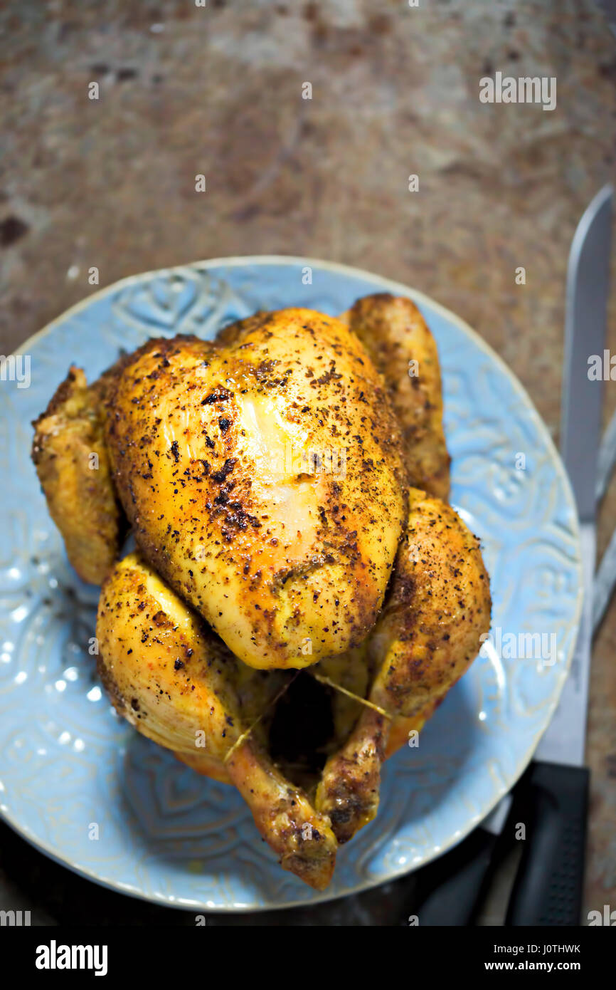 Roasted chicken on blue plate Stock Photo - Alamy