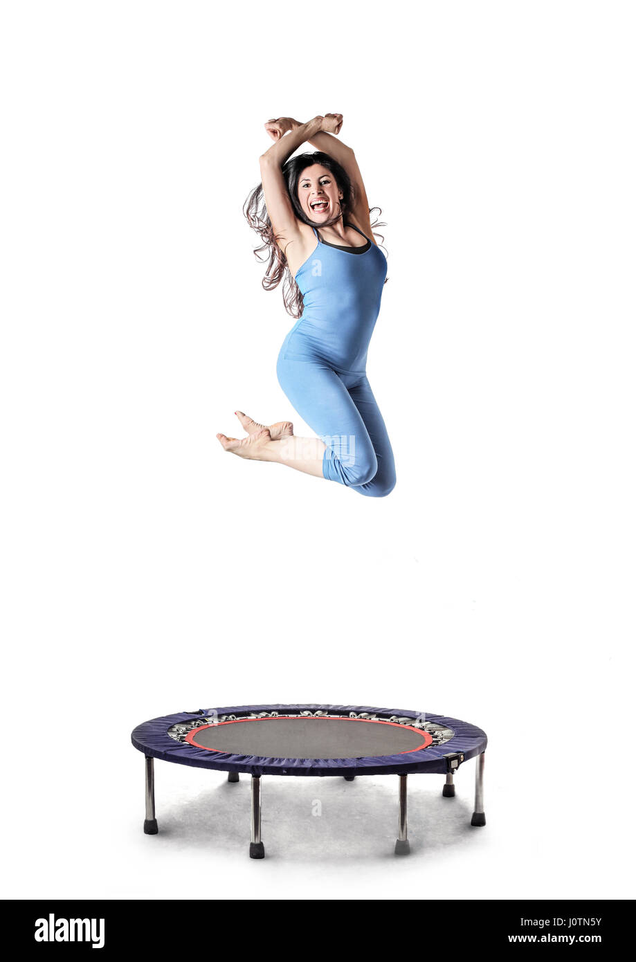 Woman jumping on trampoline Stock Photo - Alamy