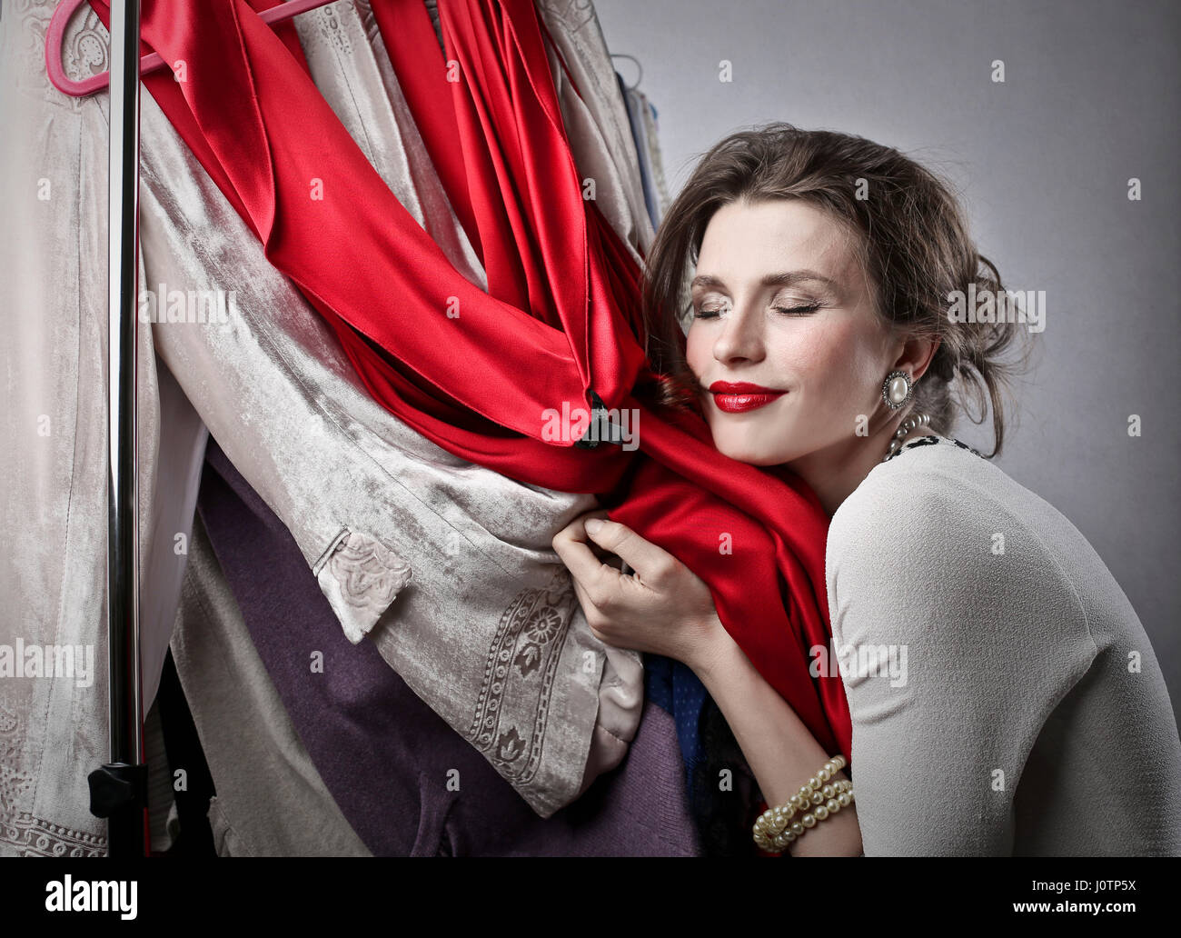 Woman hugging clothes Stock Photo - Alamy