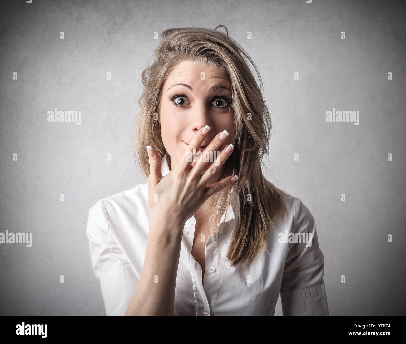 Blond woman looking surprised Stock Photo - Alamy