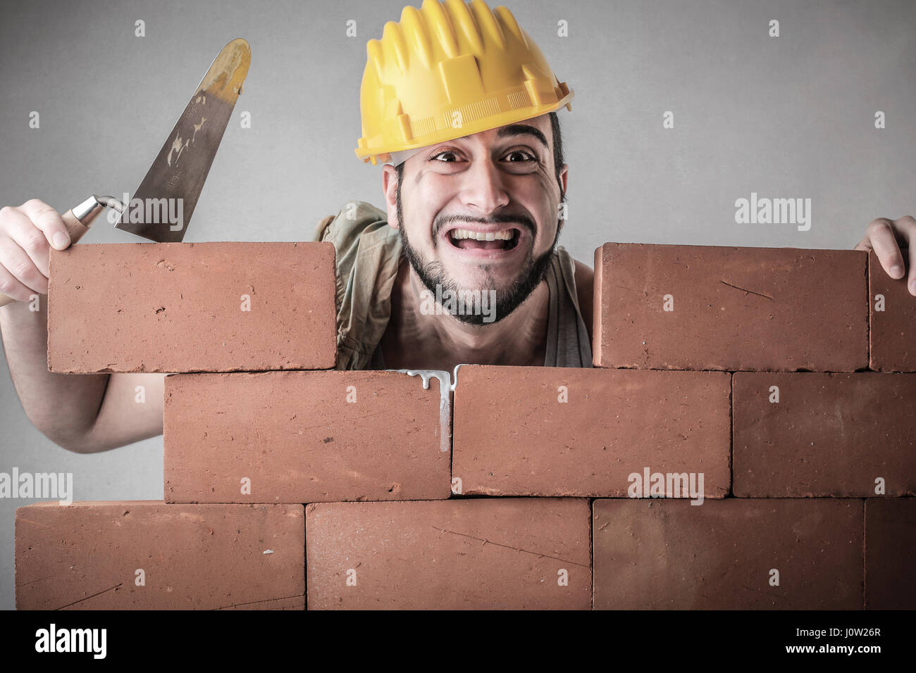 Construction worker man building wall Stock Photo - Alamy