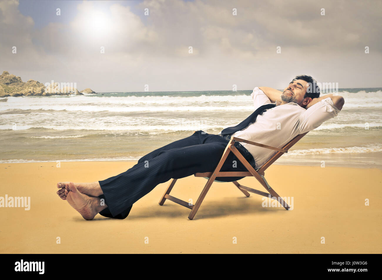 Businessman relaxing on beach hi-res stock photography and images - Alamy