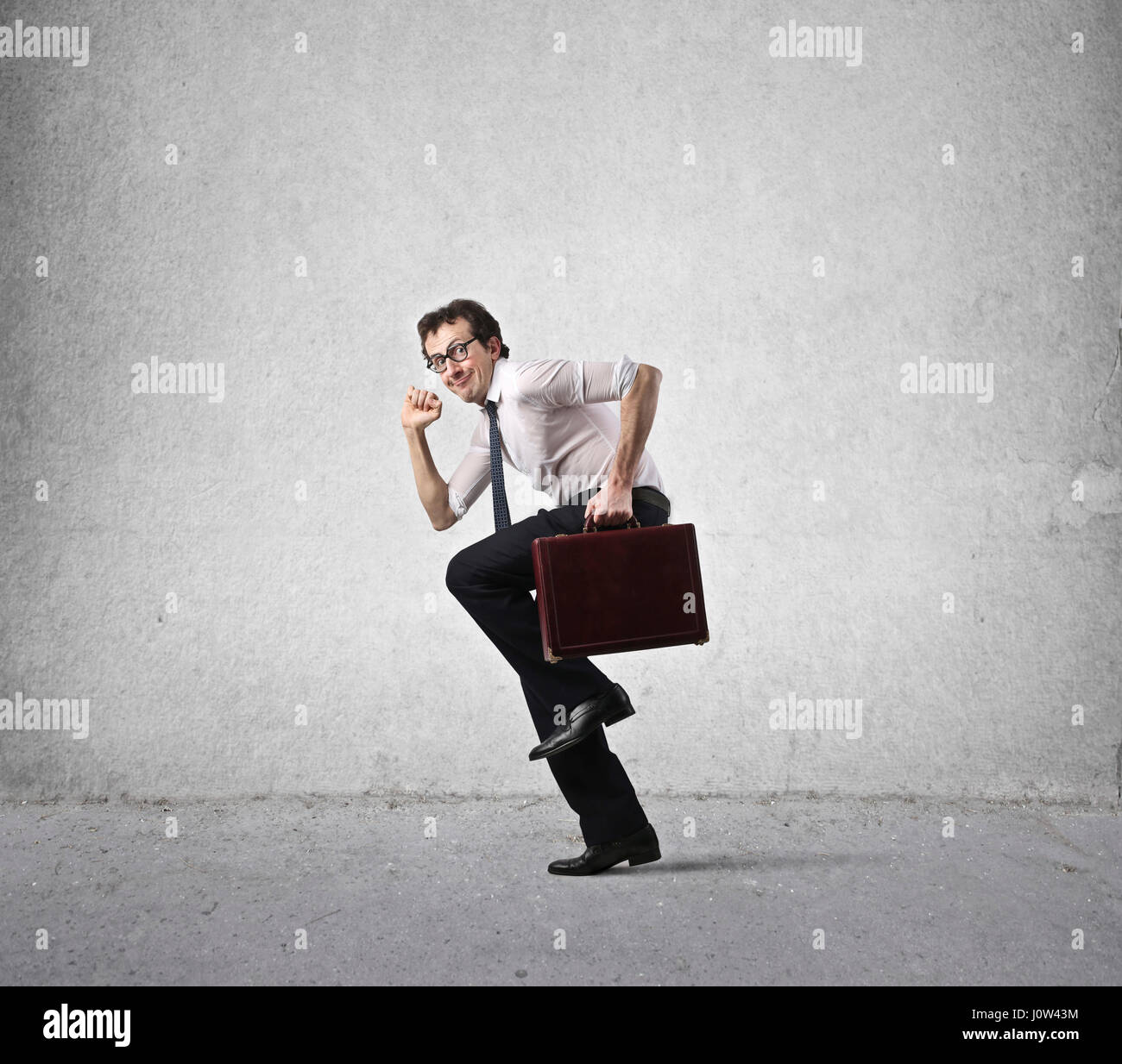 Businessman with briefcase running Stock Photo - Alamy