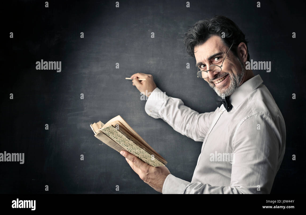 Man teaching in front of board Stock Photo - Alamy
