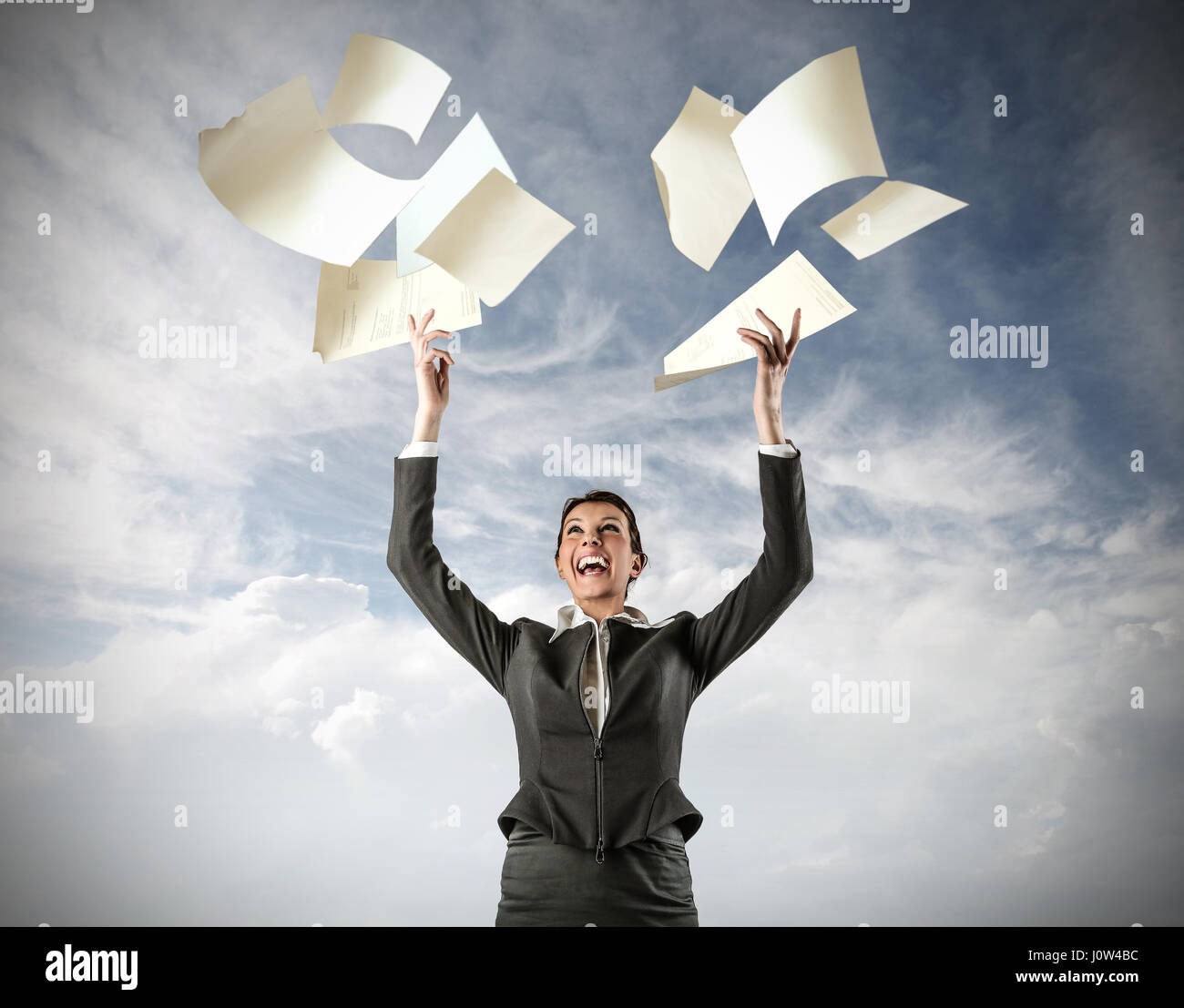 Businesswoman throwing out papers Stock Photo - Alamy