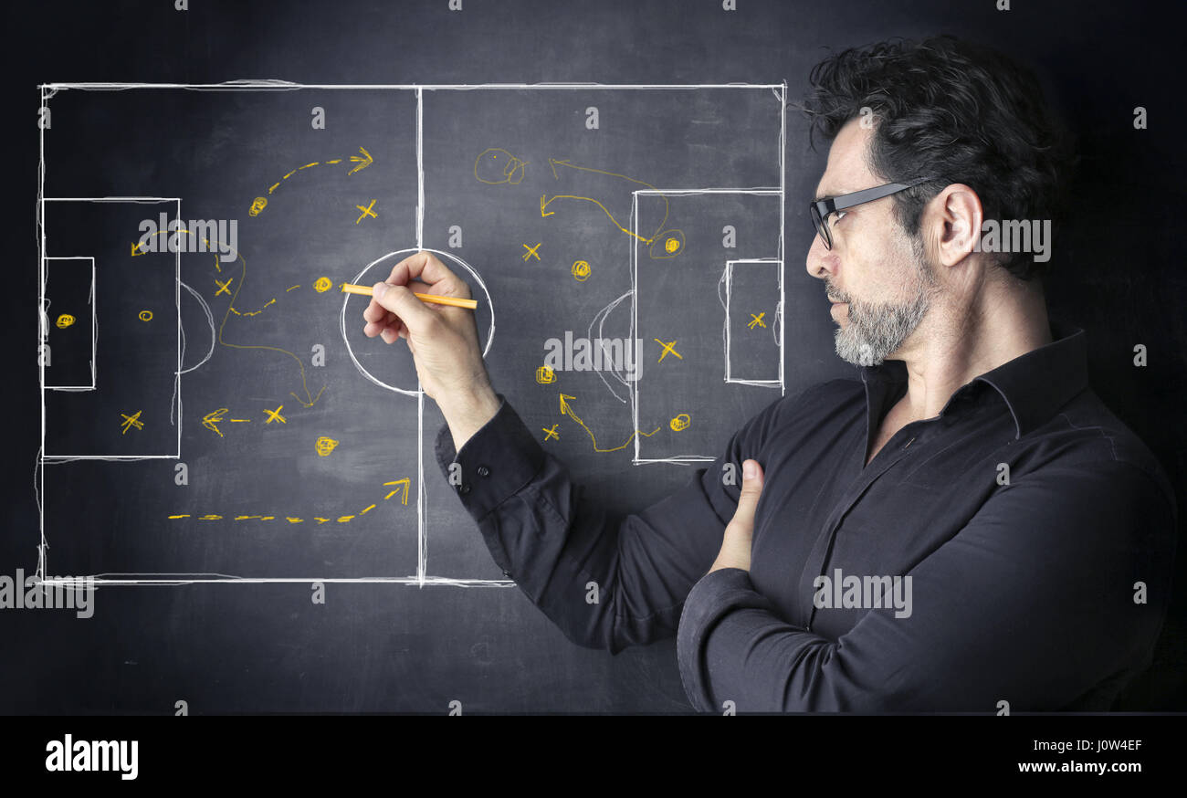 Football coach planning the game Stock Photo - Alamy
