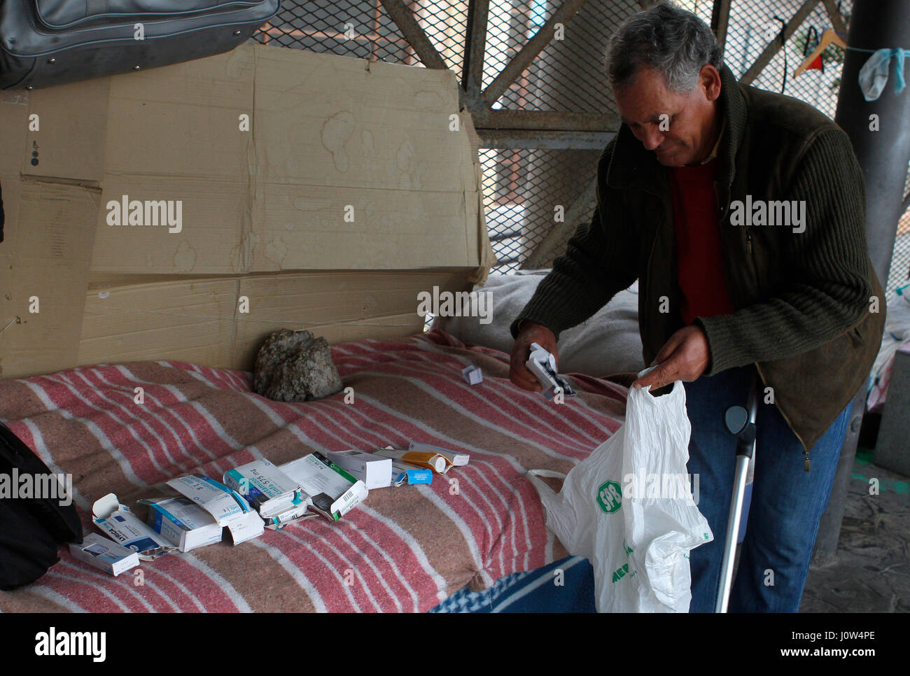 Homeless men living on a bench in a public park in the spanish island ...