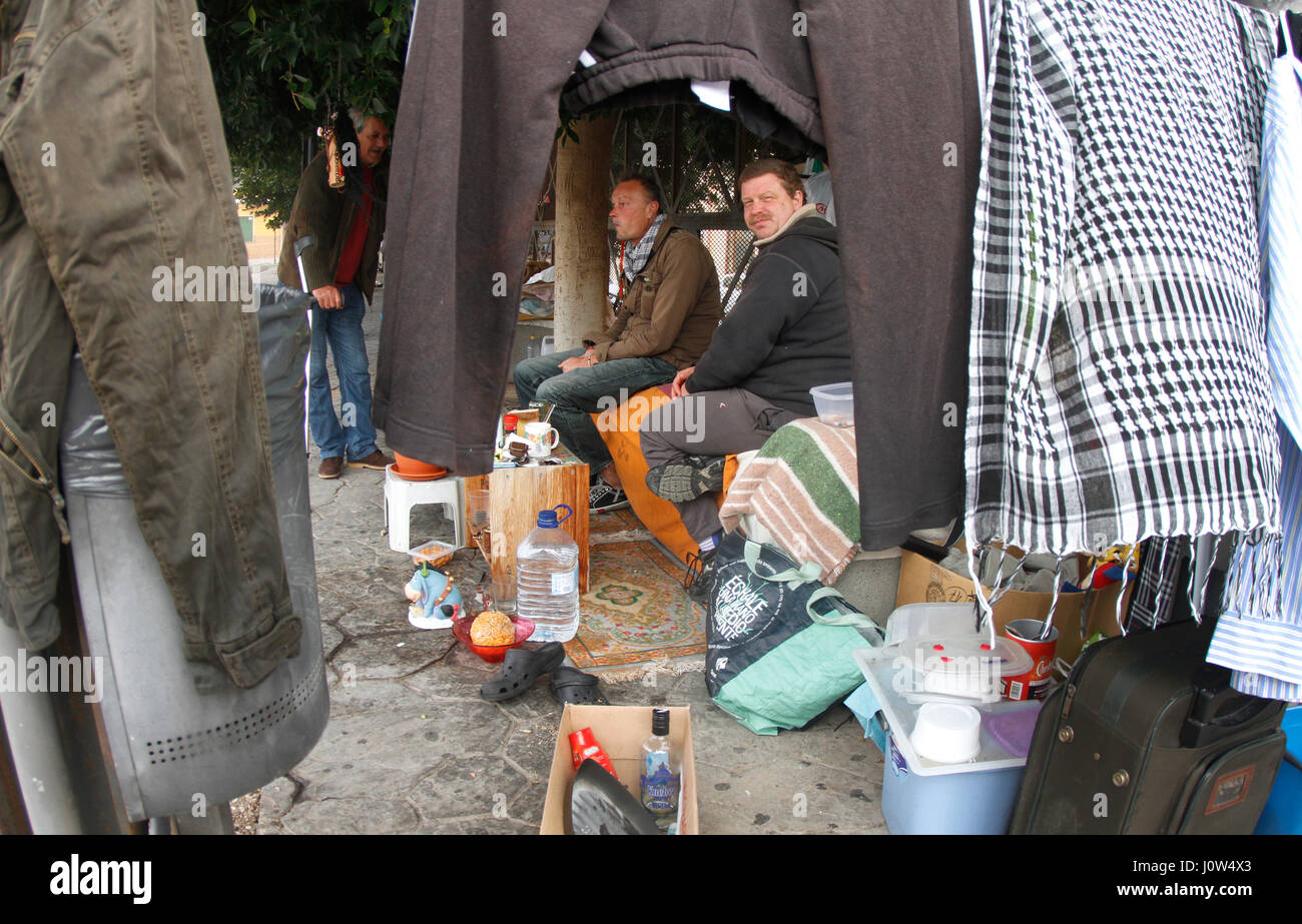Homeless men living on a bench in a public park in the spanish island ...