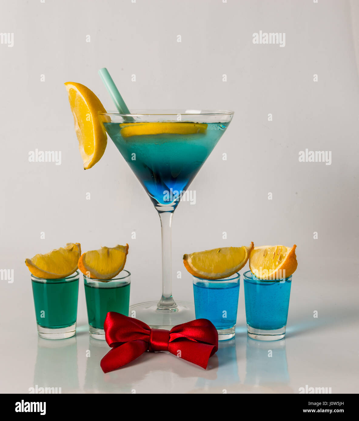 Colorful drink in a martini glass, blue and green combination, four ...