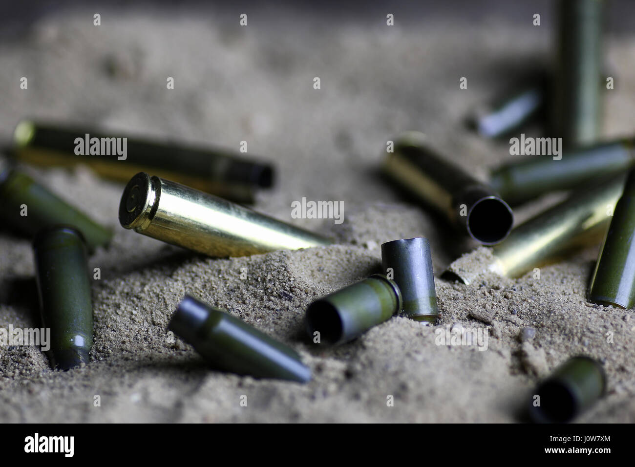 bullet in the sand Stock Photo - Alamy