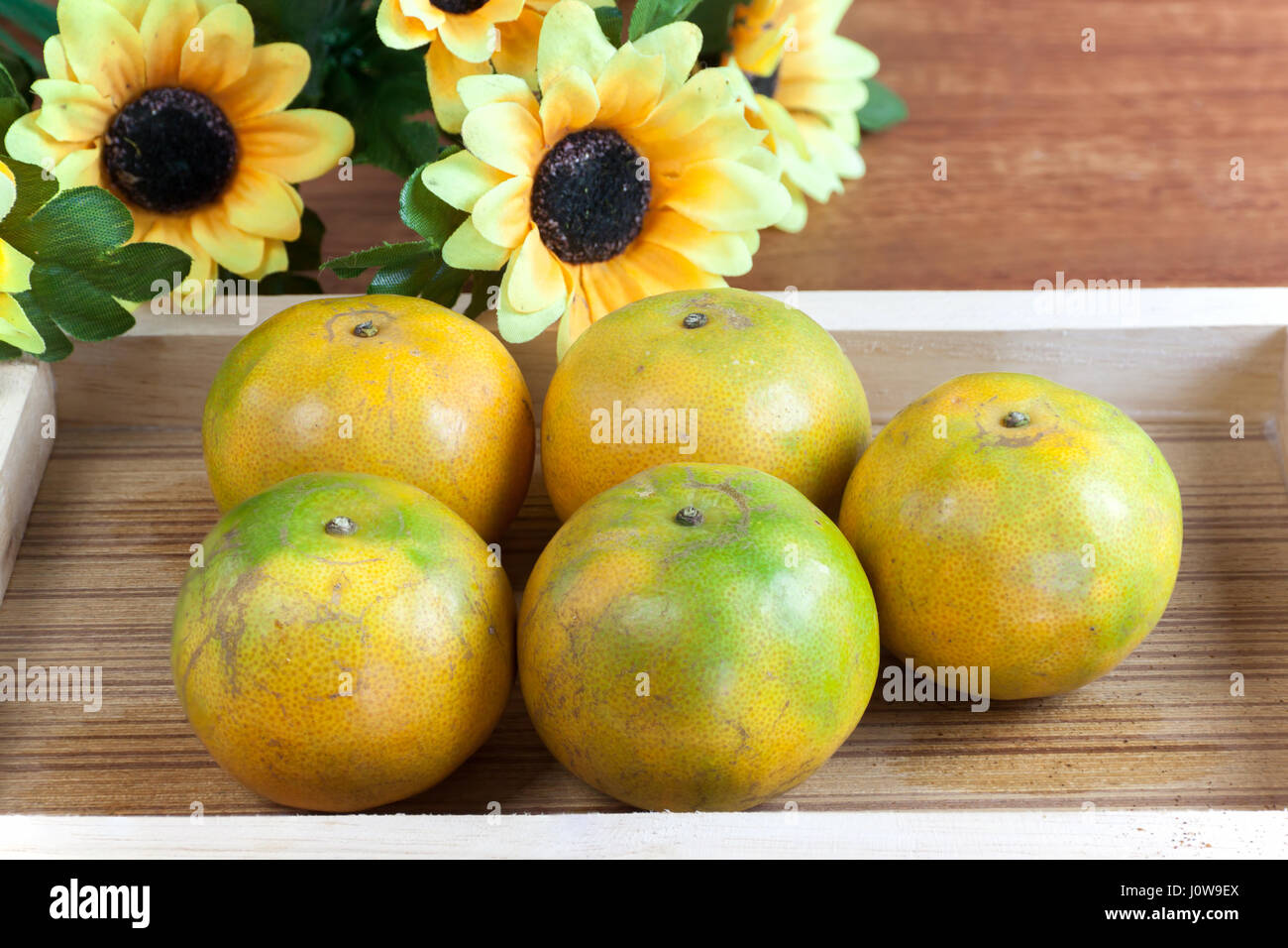 Ripe fruit orange in wooden tray on wood table Stock Photo - Alamy