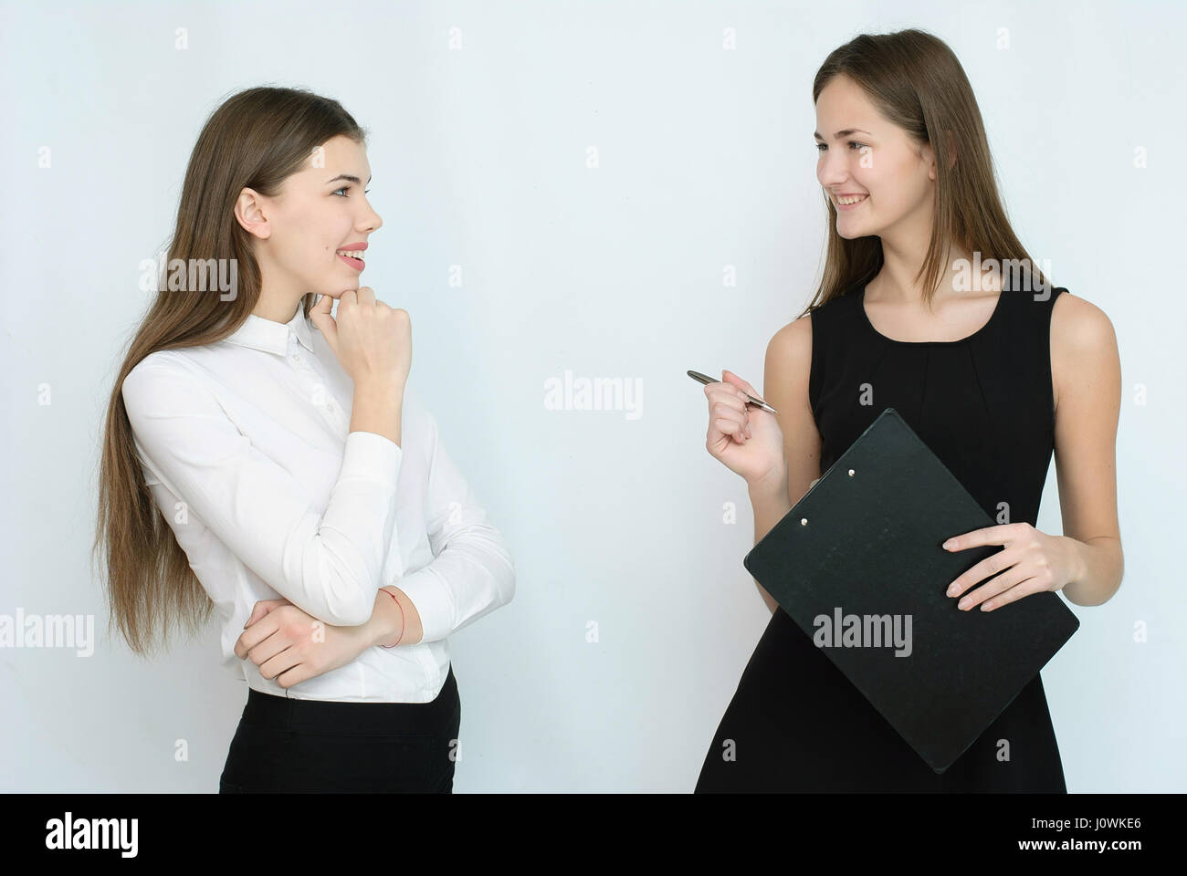 two business woman standing with their backs together Stock Photo - Alamy