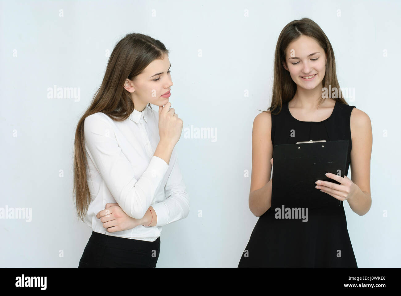 two business woman standing with their backs together Stock Photo - Alamy