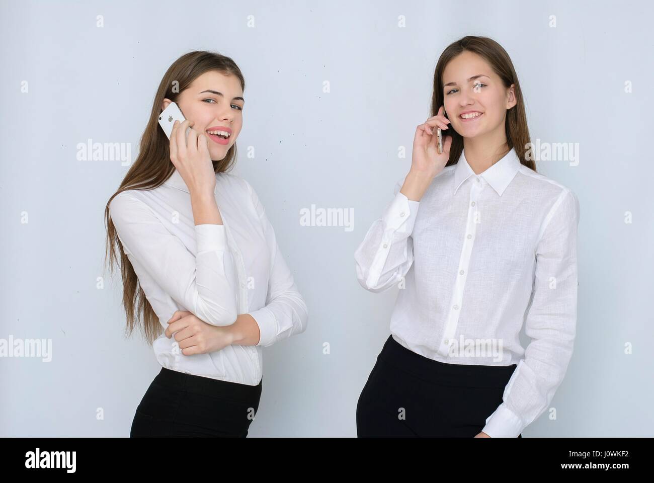 Isolated portrait of two young woman phone call. Isolated beautiful ...