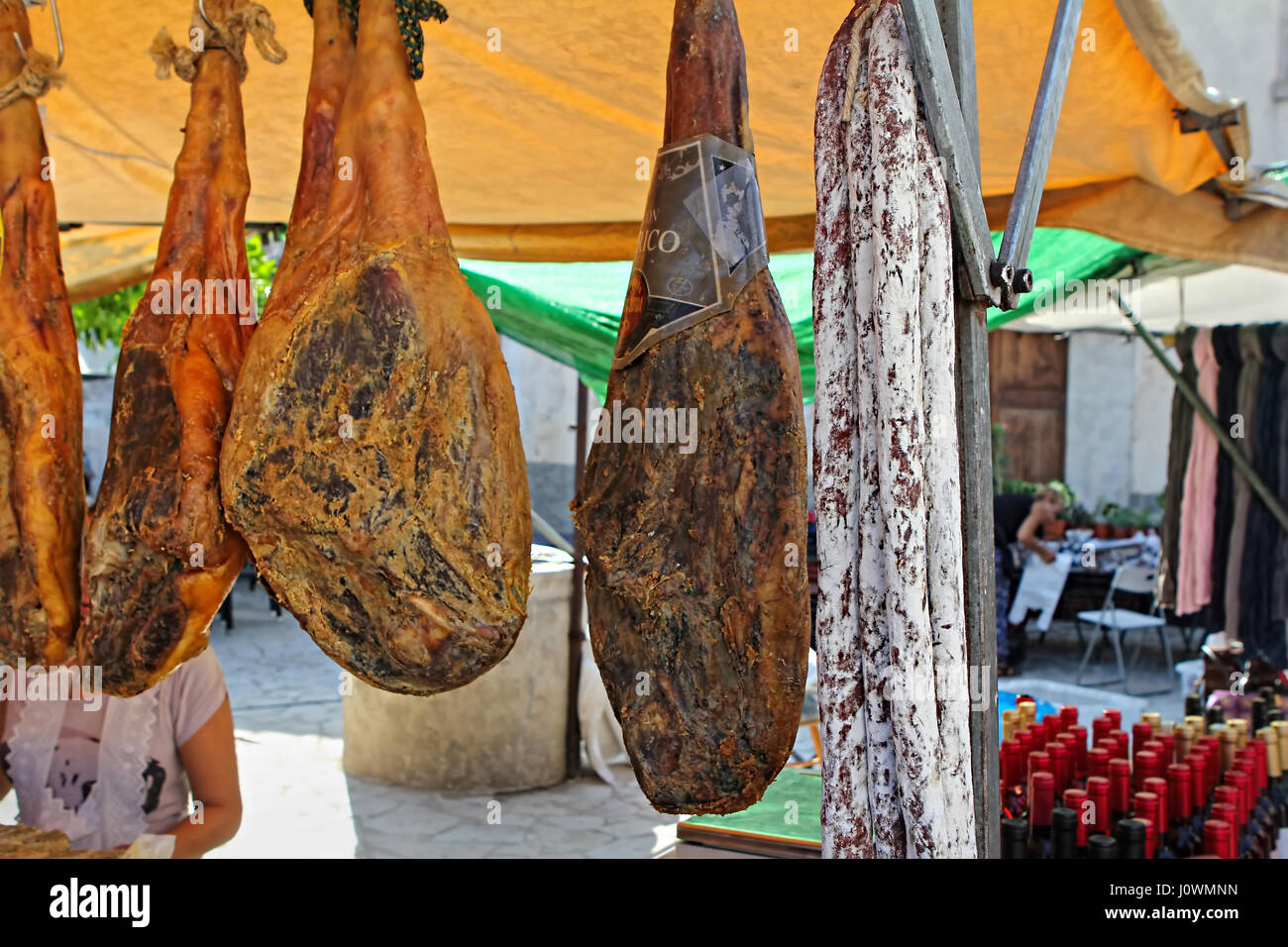 Traditional spanish legs ham and red wine on food market Stock Photo ...