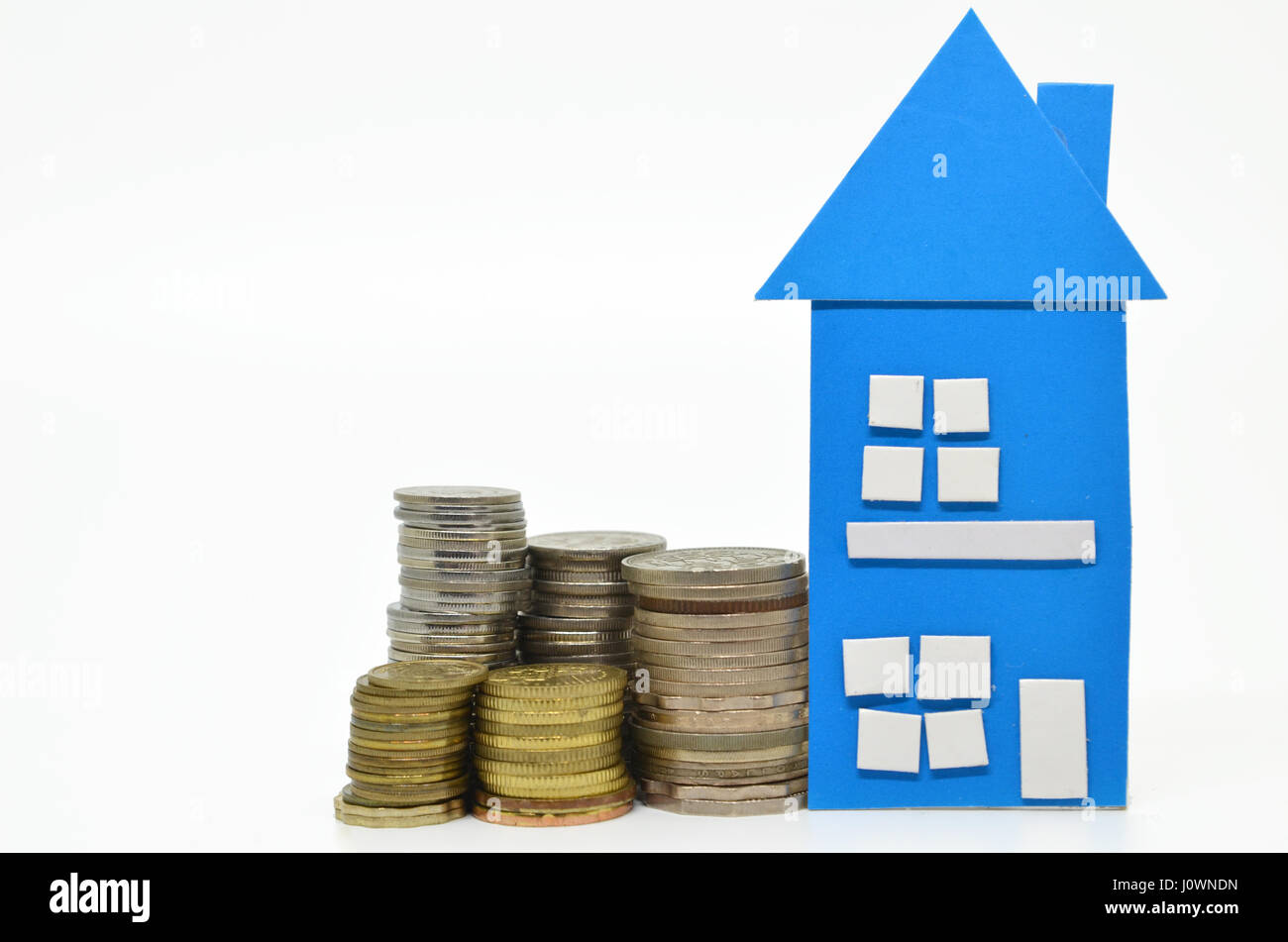 Blue paper house model and stacks of coins Stock Photo - Alamy