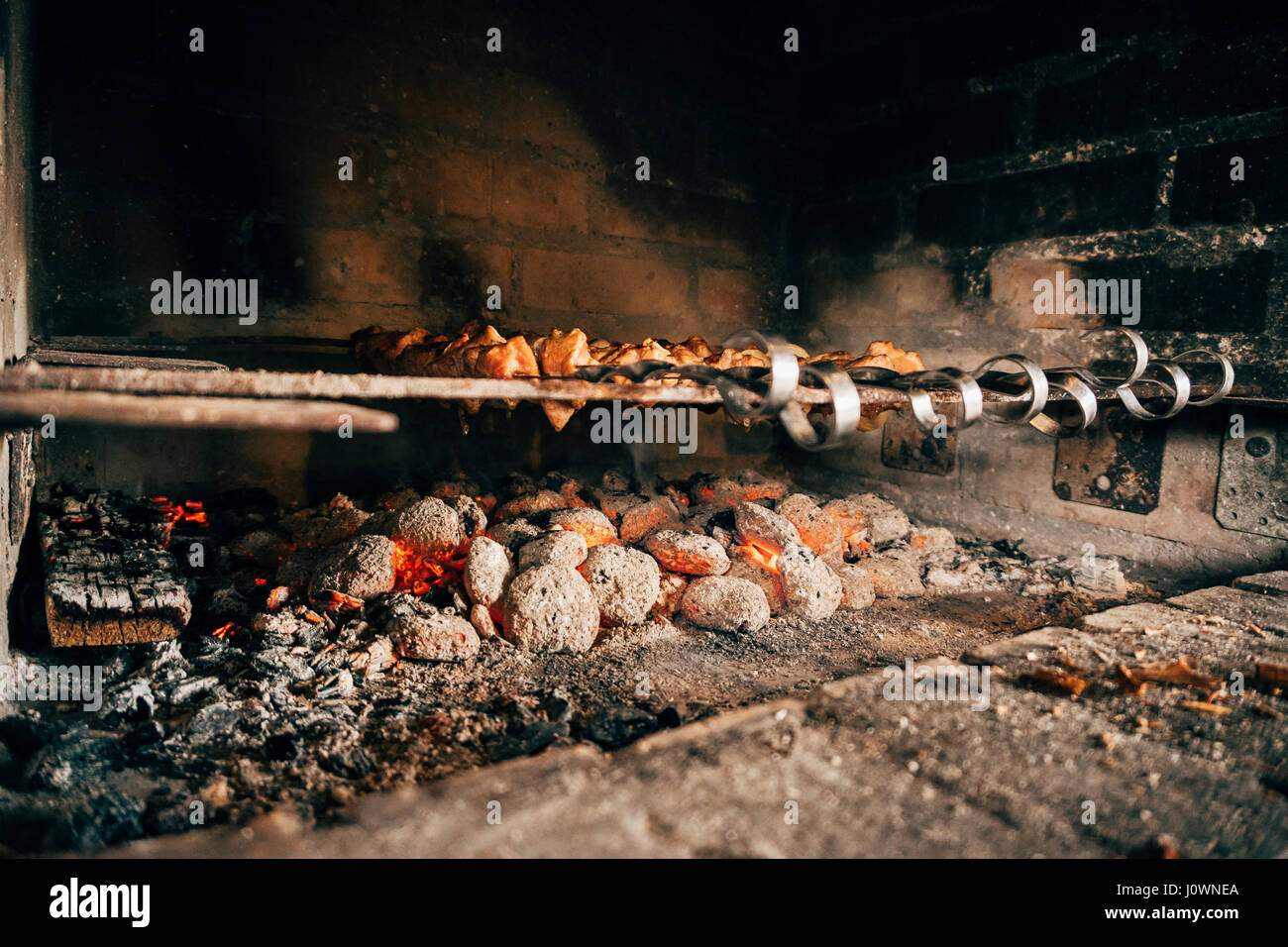Shish kebab on skewers on a stone brazier over red coals Stock Photo ...