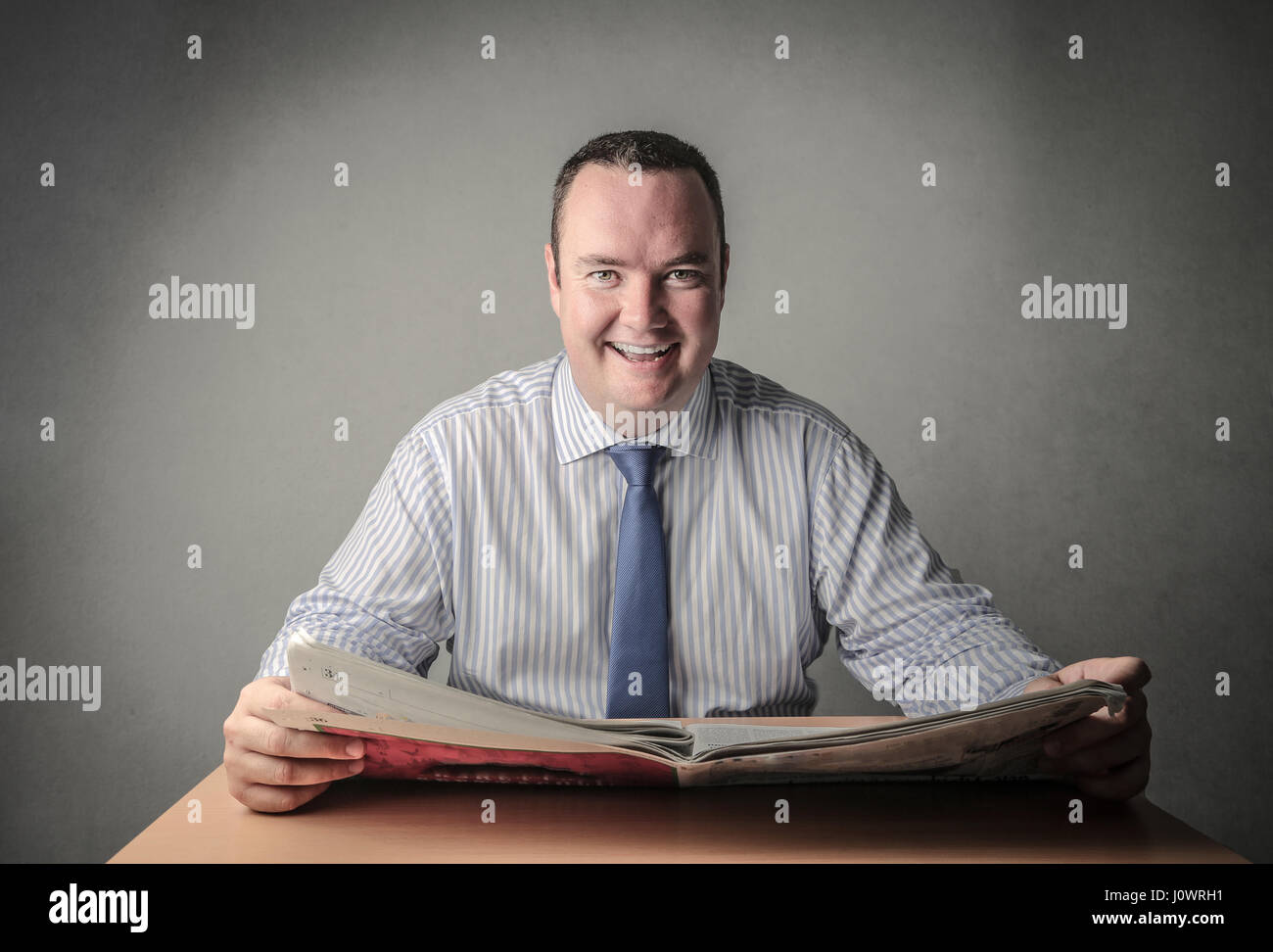 Businessman holding huge book Stock Photo - Alamy