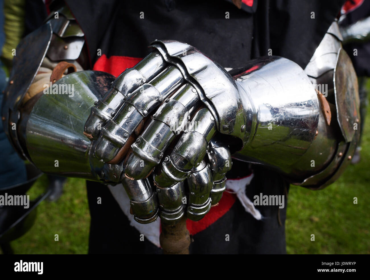 A man dressed in knights armour waits in preparation for a battle at ...