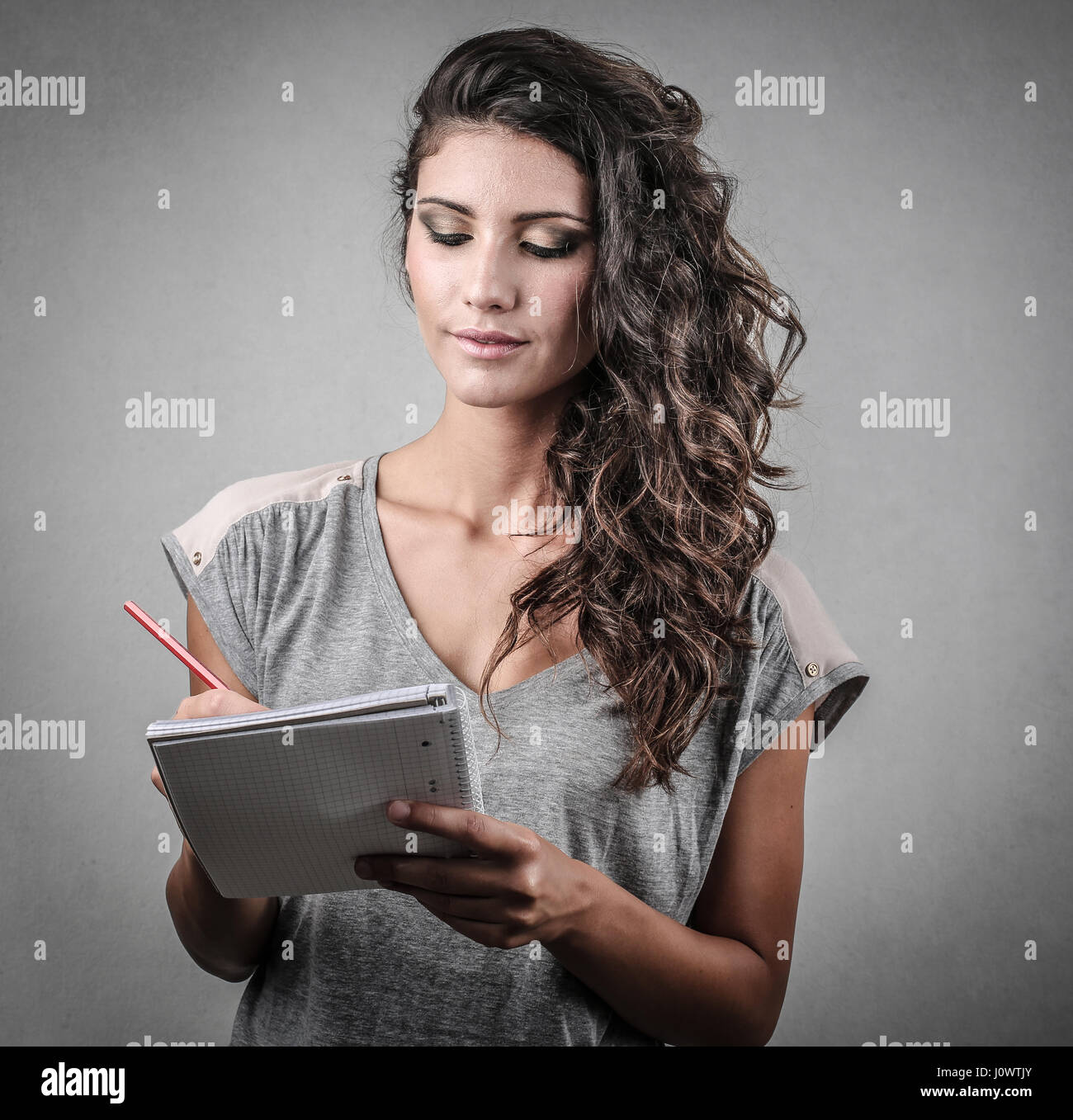 Brunette woman taking notes Stock Photo - Alamy
