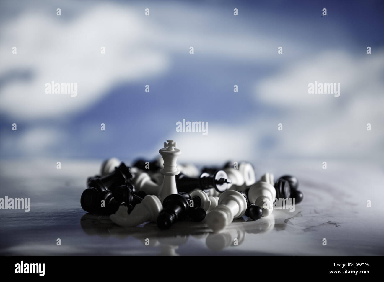 One chess is staying against full army of chess pieces. Chess strategy ...