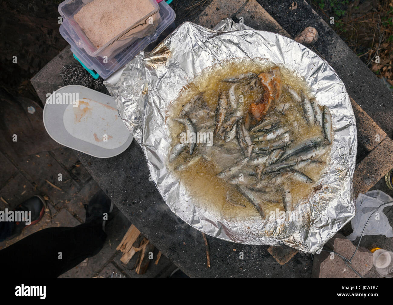 frying small fish in oil, close up Stock Photo - Alamy