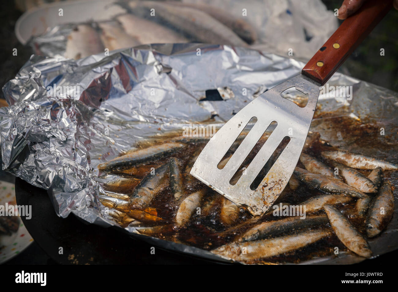 frying small fish in oil, close up Stock Photo - Alamy