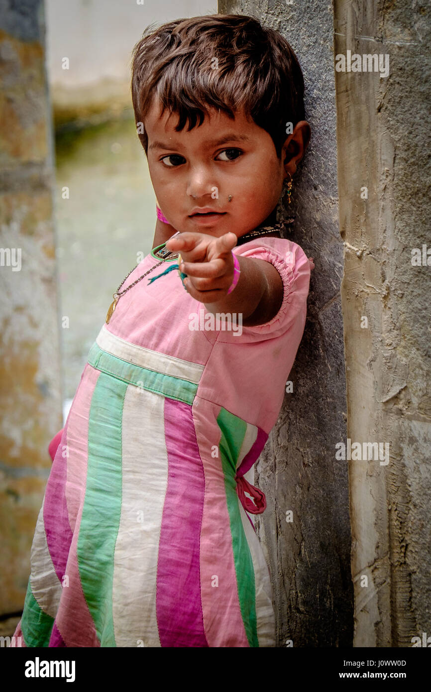 A small child in Udaipur, India stands pointing Stock Photo - Alamy