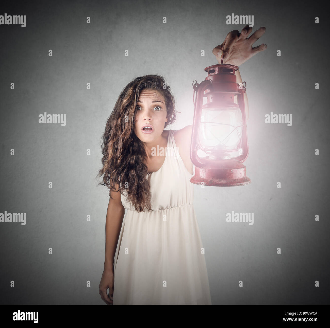 Brunette woman with lamp Stock Photo - Alamy