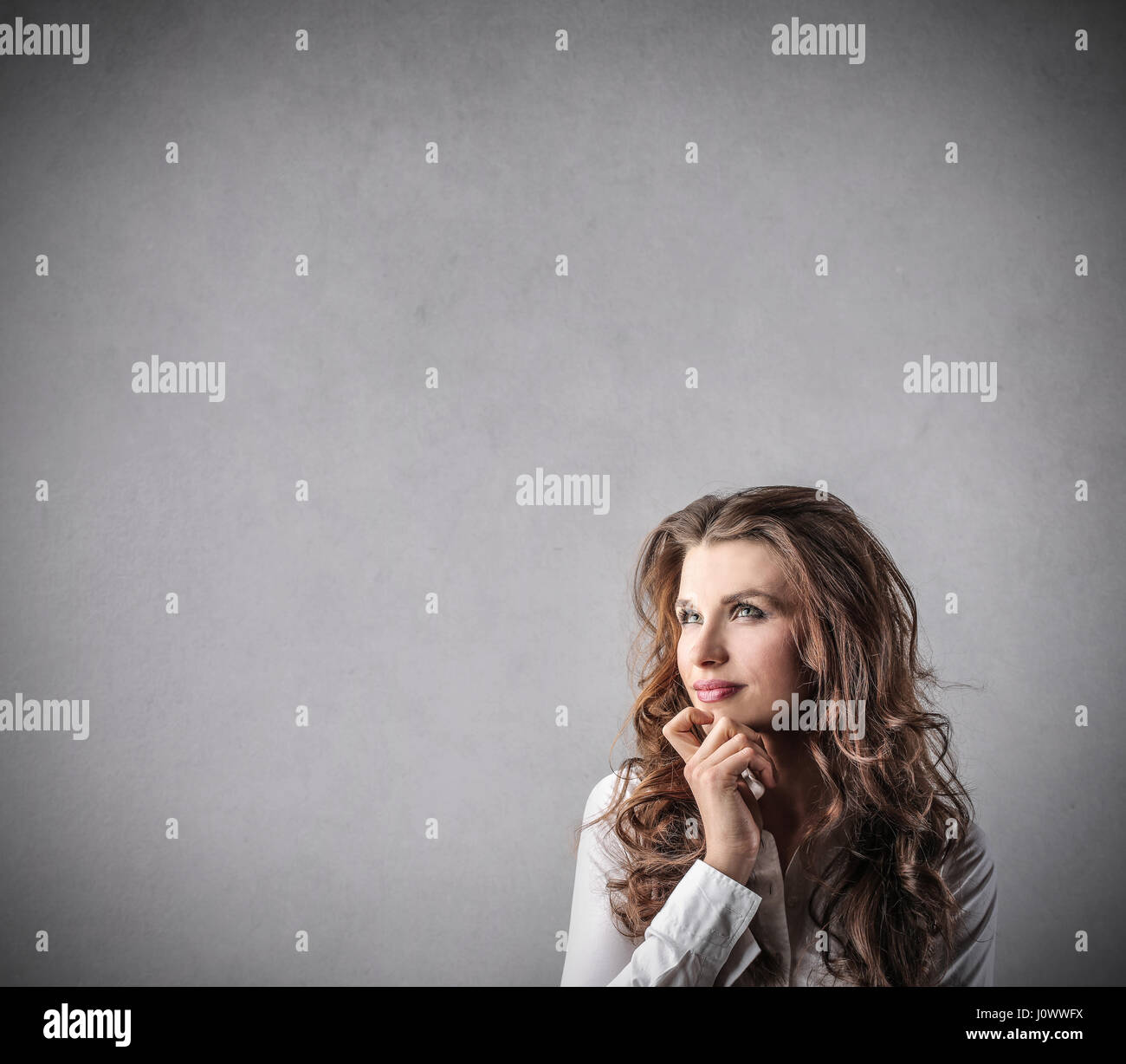 Brunette woman thinking inside Stock Photo - Alamy
