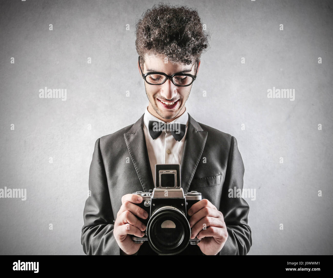 Young man with old camera Stock Photo - Alamy
