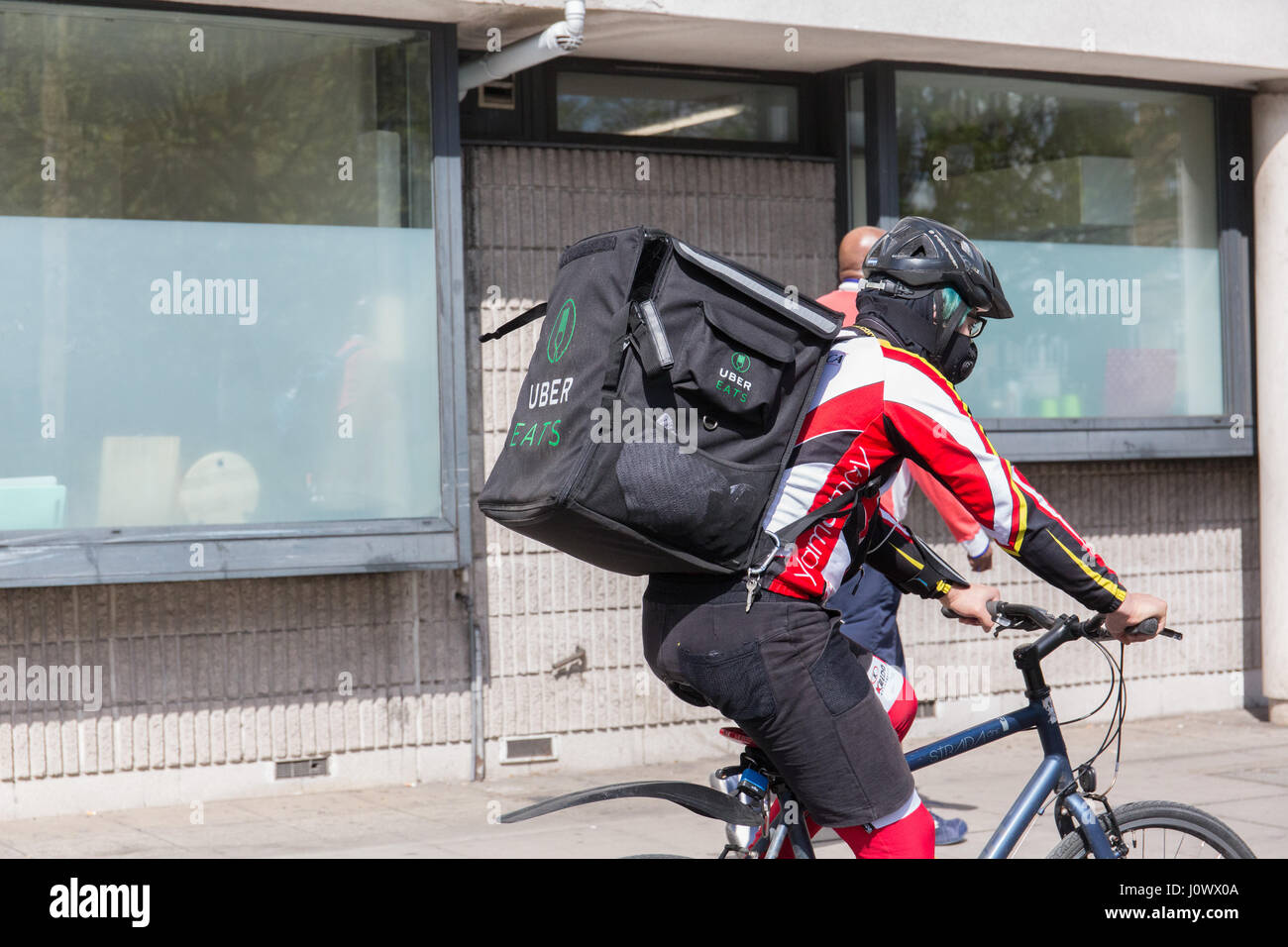 UBER eats delivery cyclist Stock Photo - Alamy