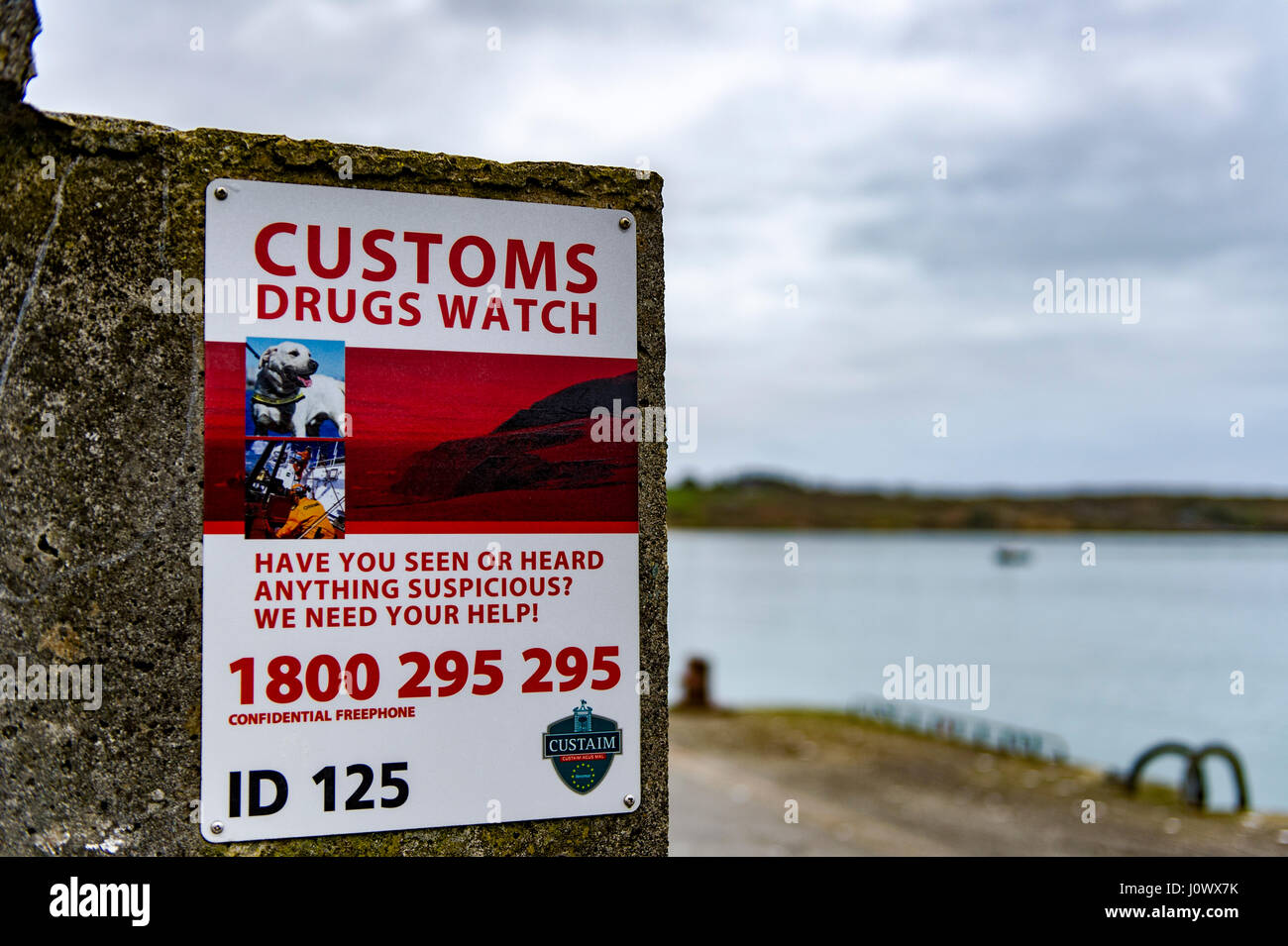 Customs Drugs Watch sign on a wall on the quay in Schull Harbour, West ...