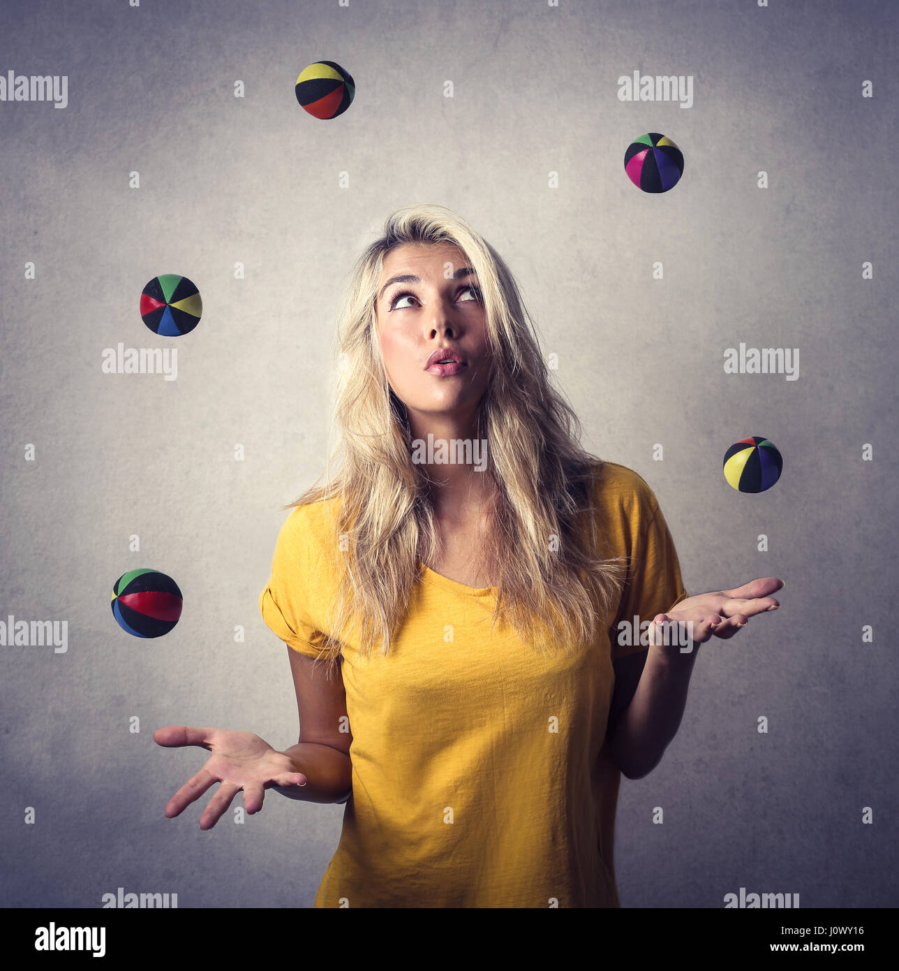 Blond woman juggling inside Stock Photo - Alamy