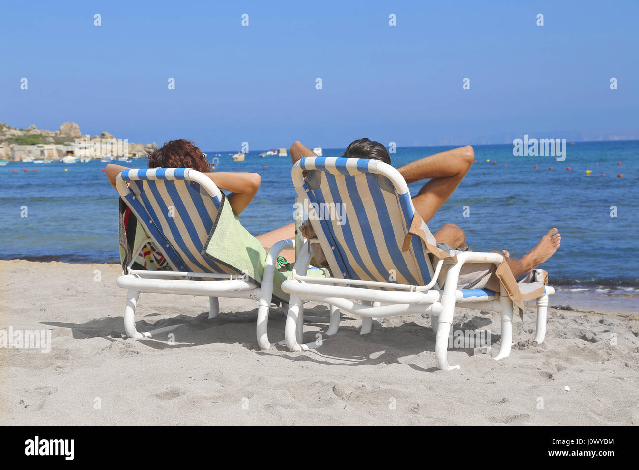 People Relaxing At The Beach