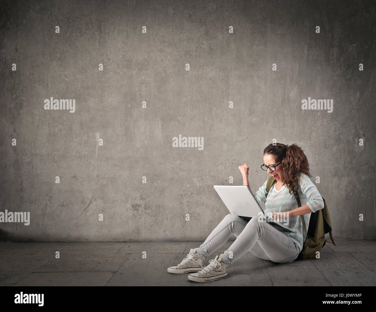 Woman with laptop feeling successful Stock Photo - Alamy