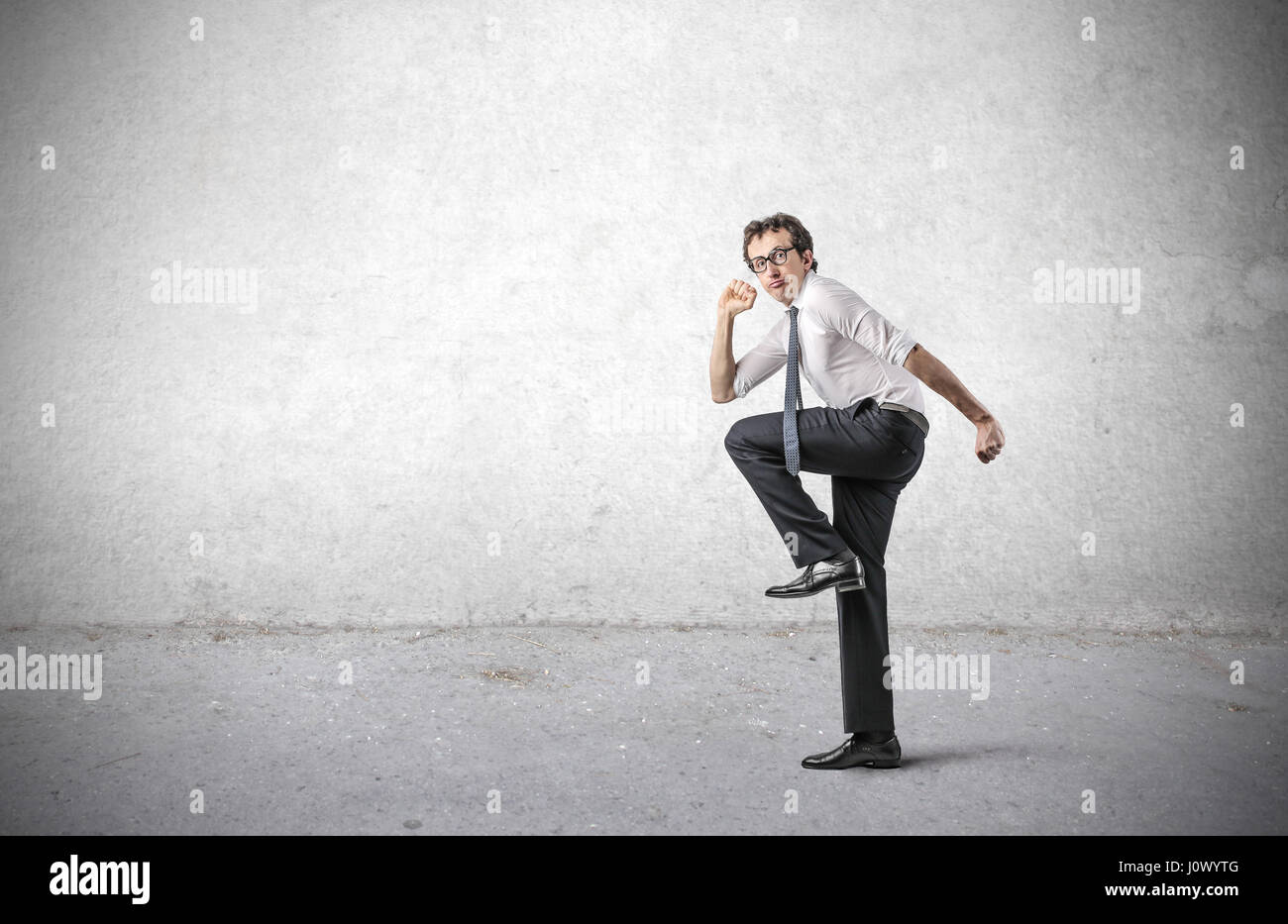 Businessman running in room Stock Photo - Alamy