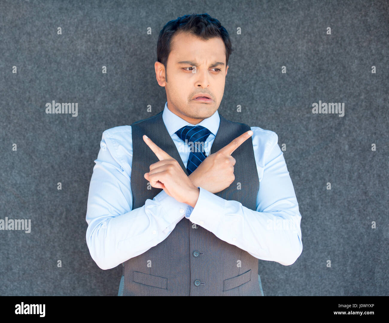 Closeup portrait of young business man thinking, daydreaming,pointing ...