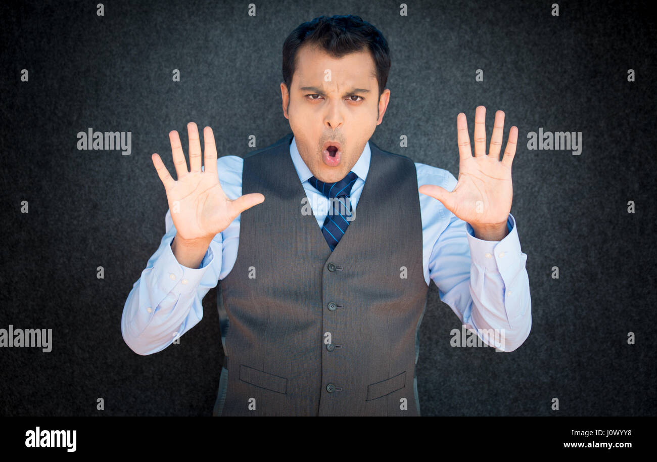 Closeup portrait of young, angry man in vest and blue tie, gesturing no ...