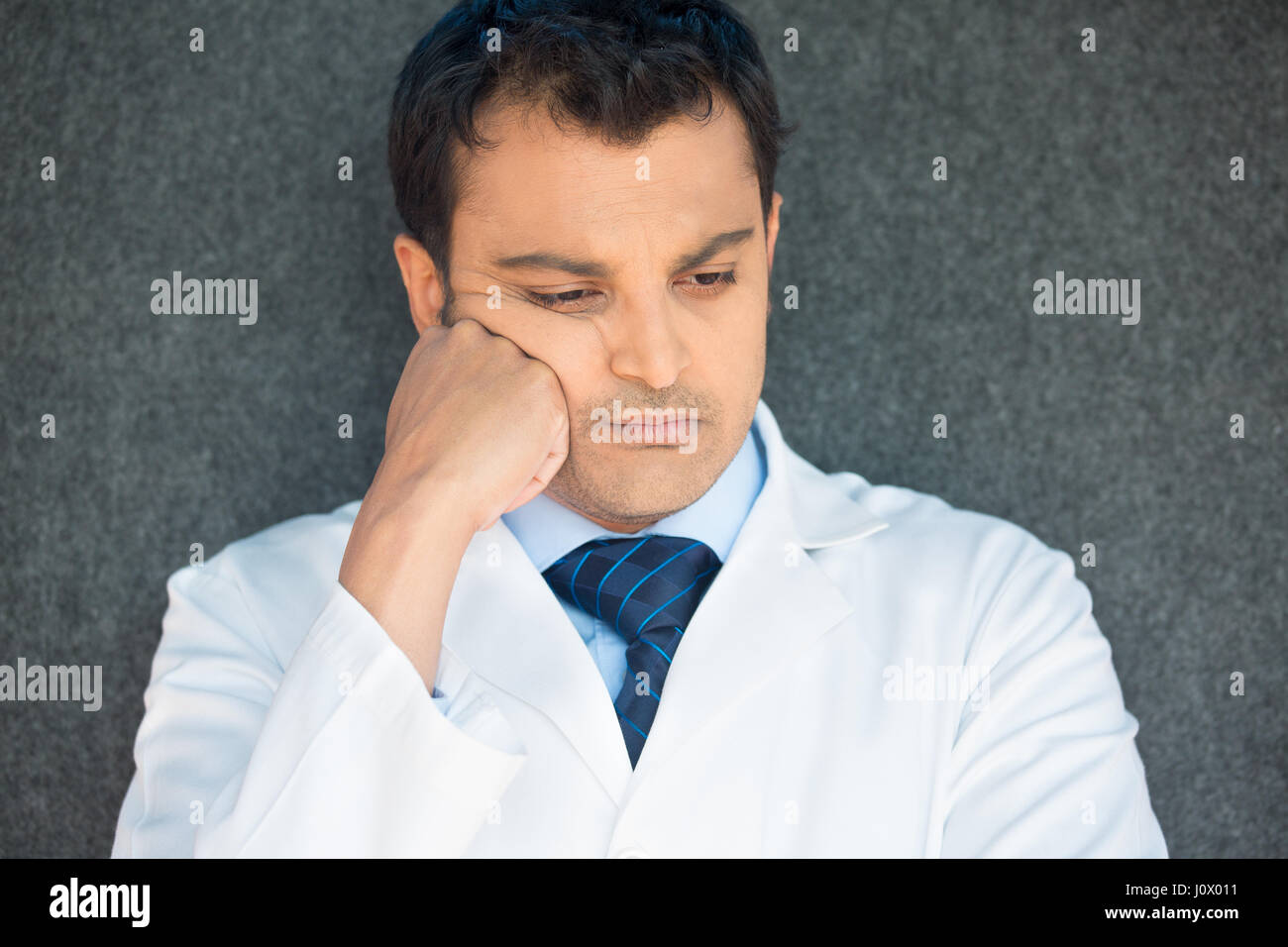Closeup portrait, young depressed man healthcare practitioner holding ...