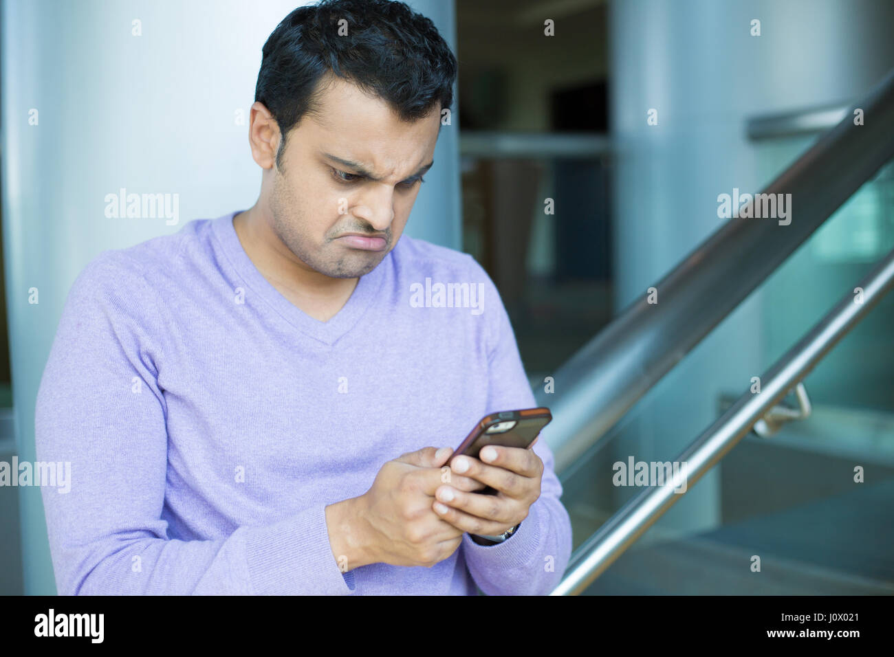 Closeup portrait, stressed young man in purple sweater, shocked ...