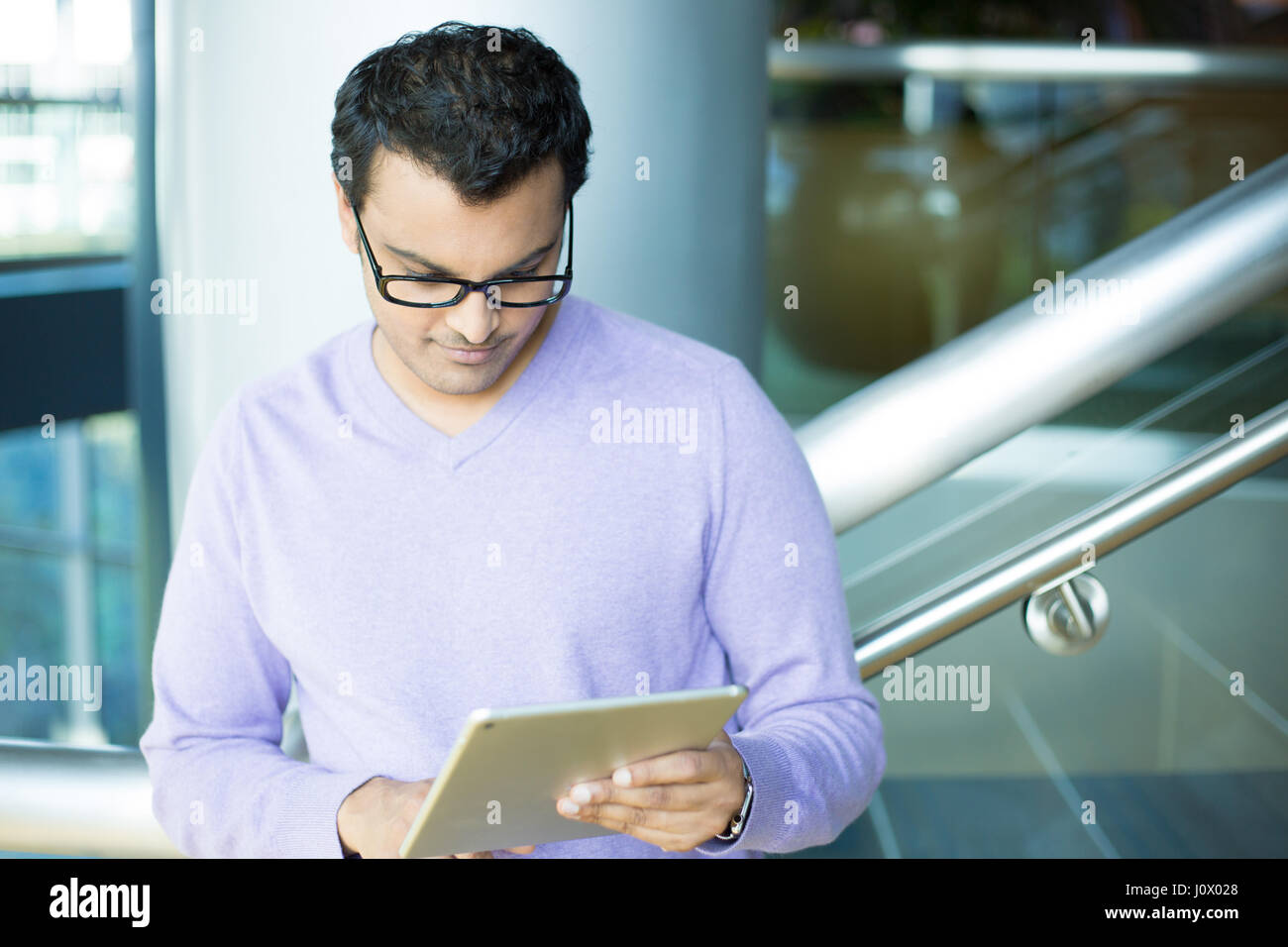 Closeup portrait, young captivated, absorbed, engrossed man in purple ...