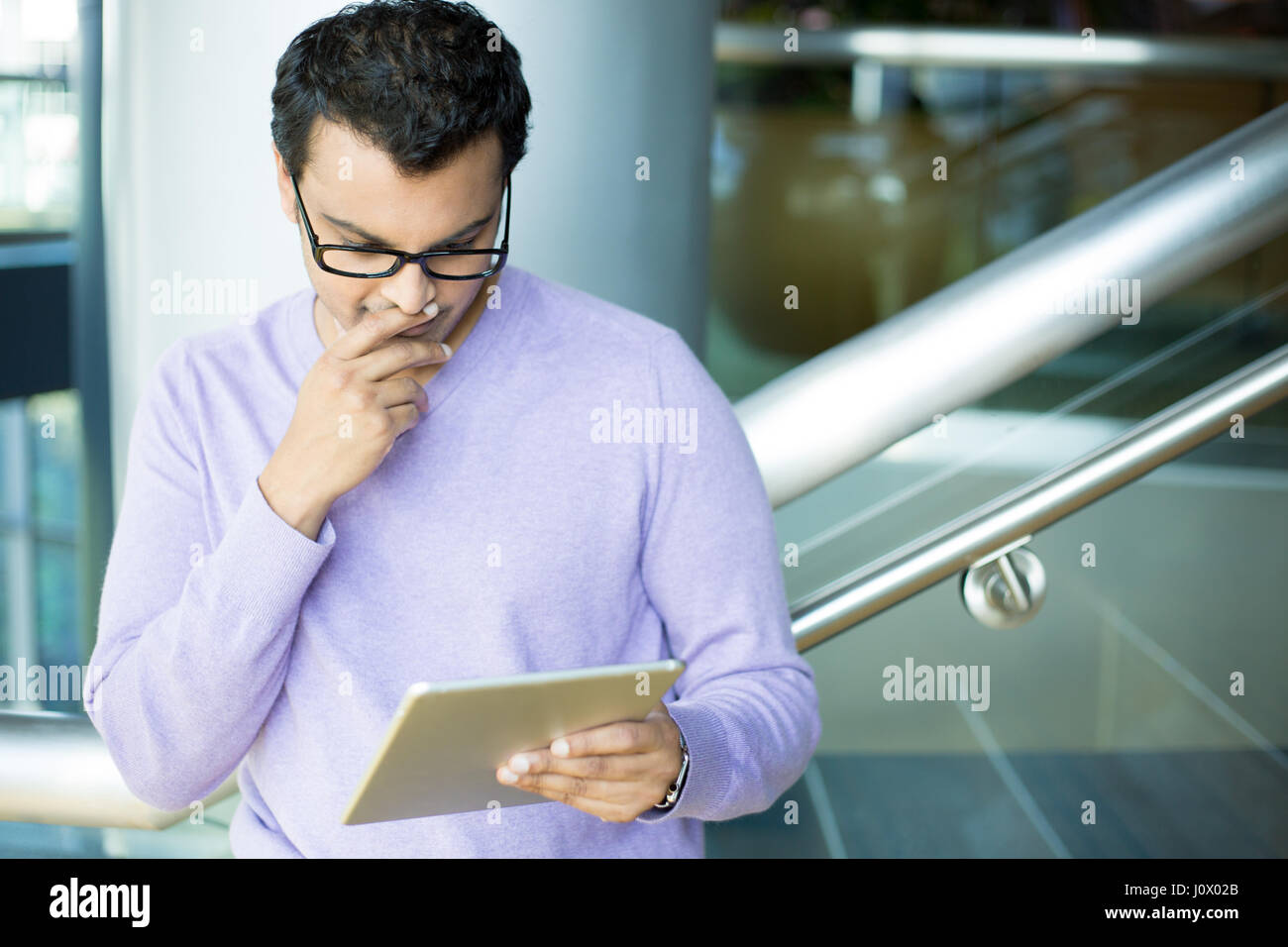 Closeup portrait, young captivated, absorbed, engrossed man in purple ...