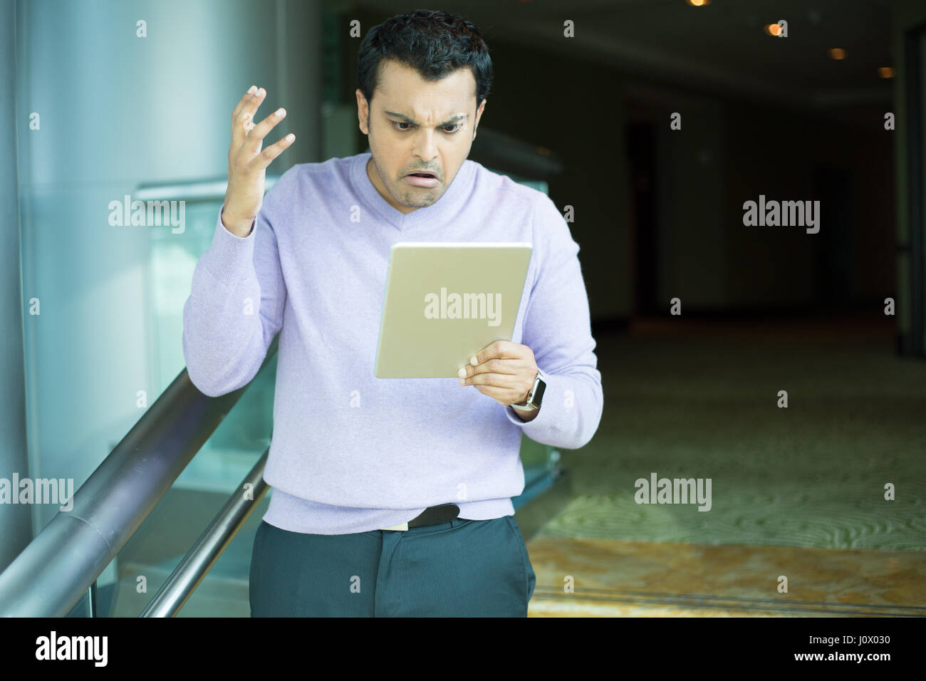 Closeup portrait, very upset, fuming, incensed man in purple sweater ...