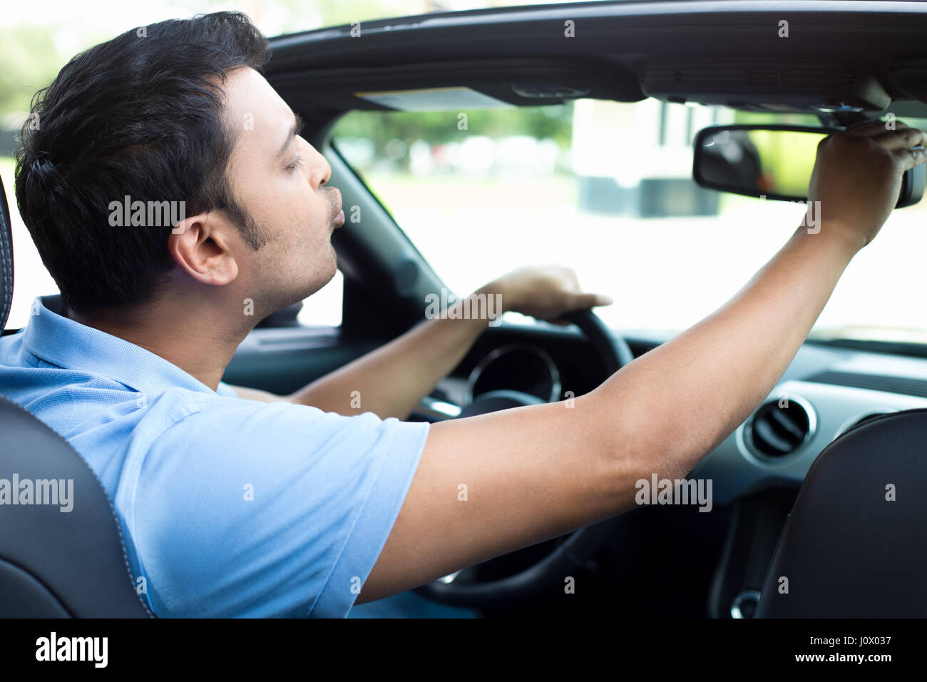 Closeup portrait, young handsome egotistical man in blue polo shirt ...