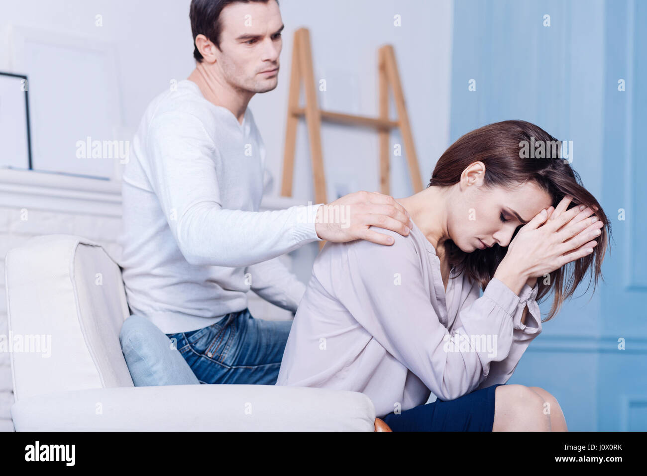 Sad young woman touching her forehead Stock Photo - Alamy