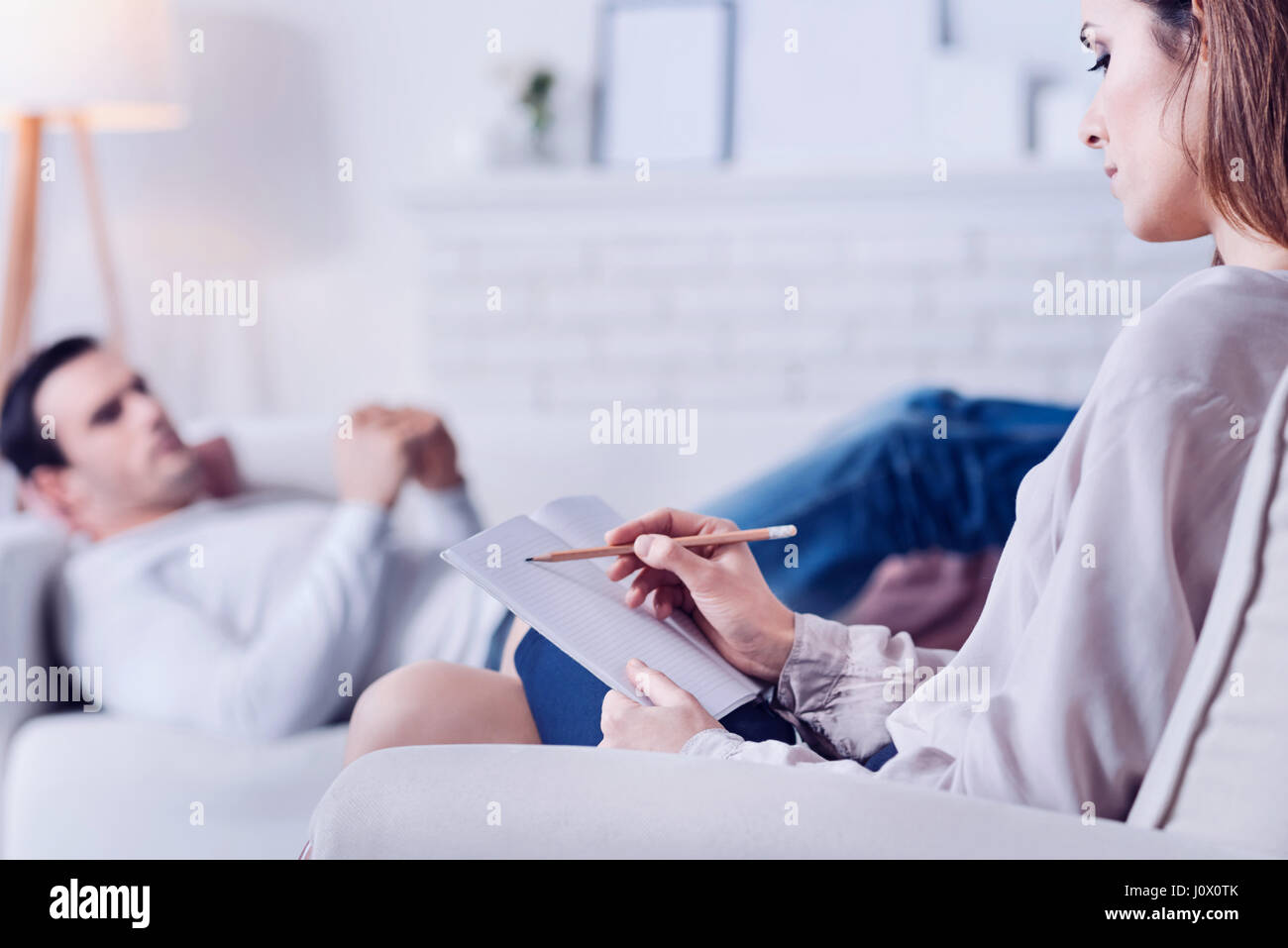 Confident professional psychologist taking notes Stock Photo - Alamy