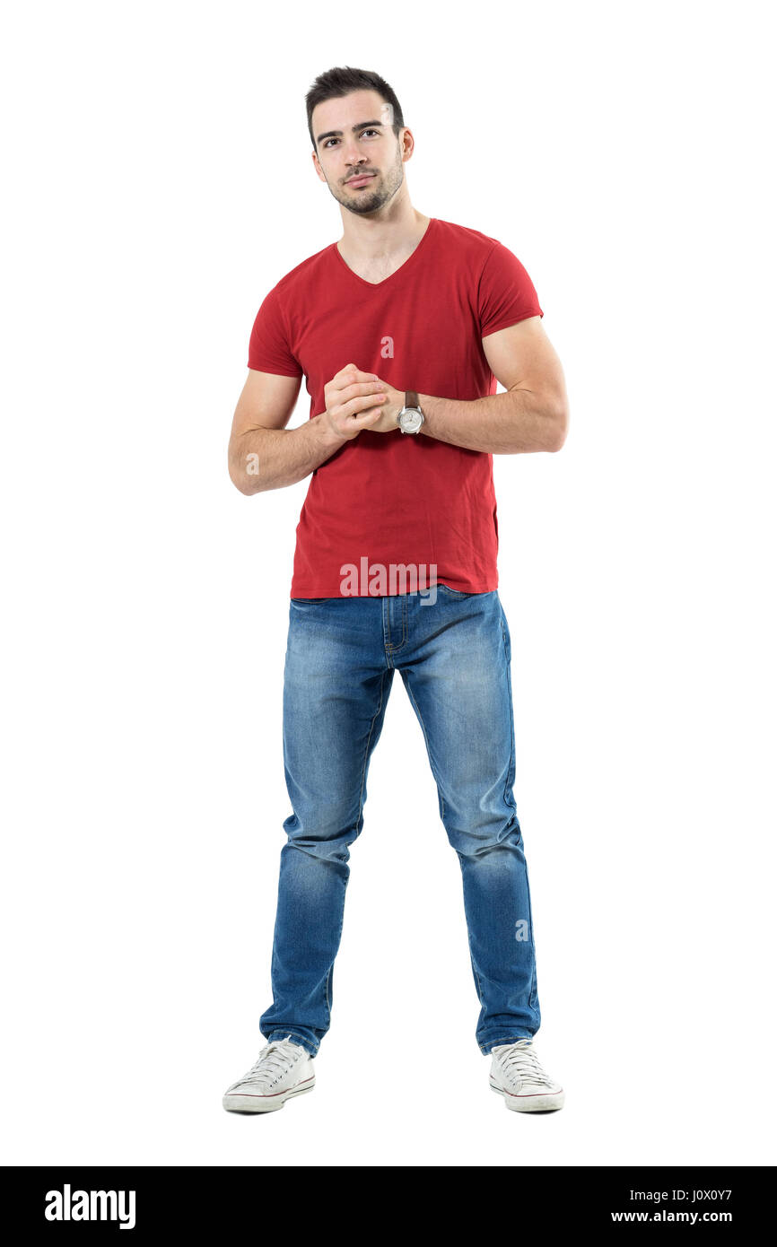 Young casual doubtful man with clasped hands looking up. Full body ...