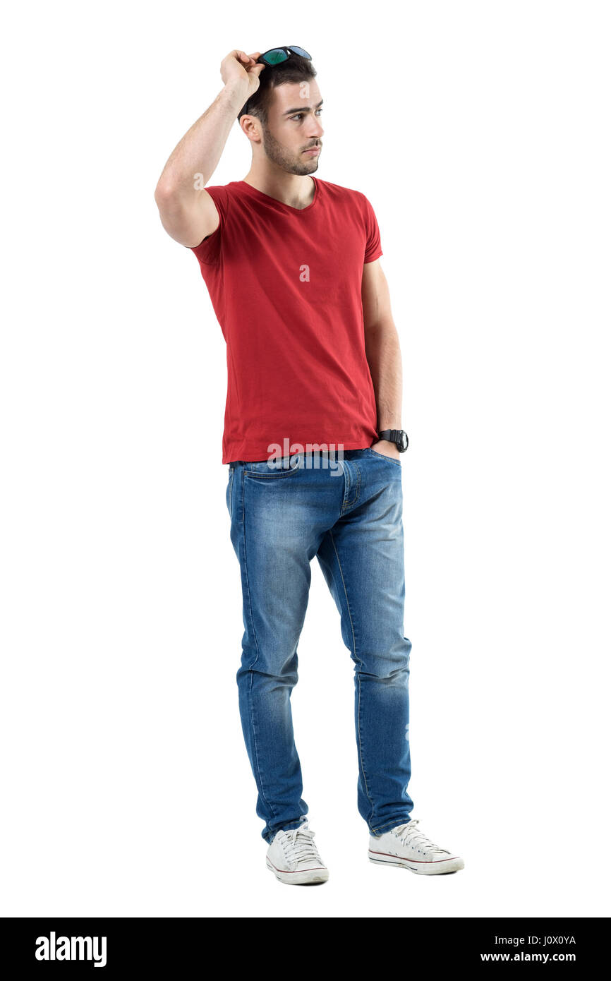 Seductive young womanizer man with sunglasses on head looking away ...