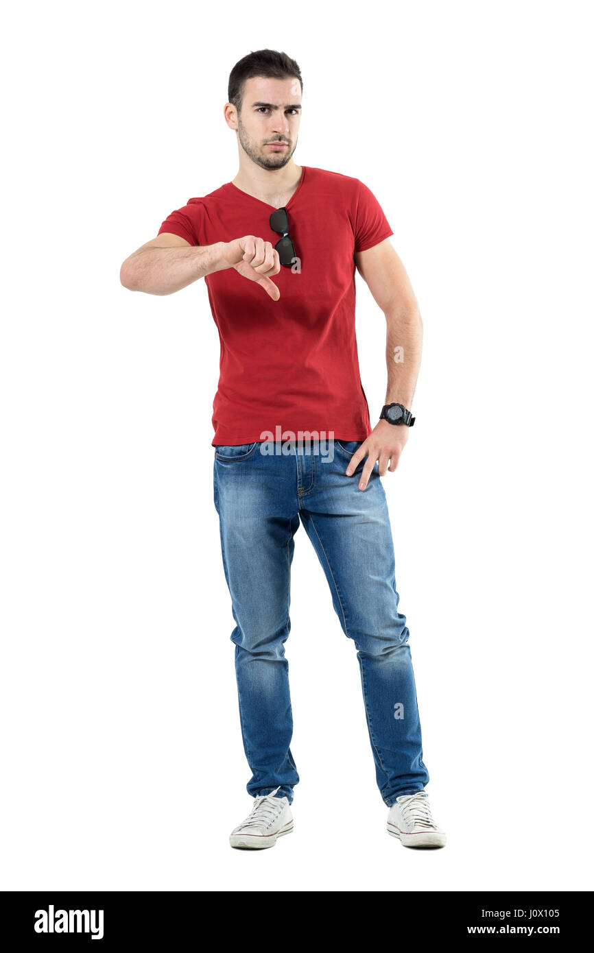 Upset angry young casual man showing thumbs down gesture. Full body ...